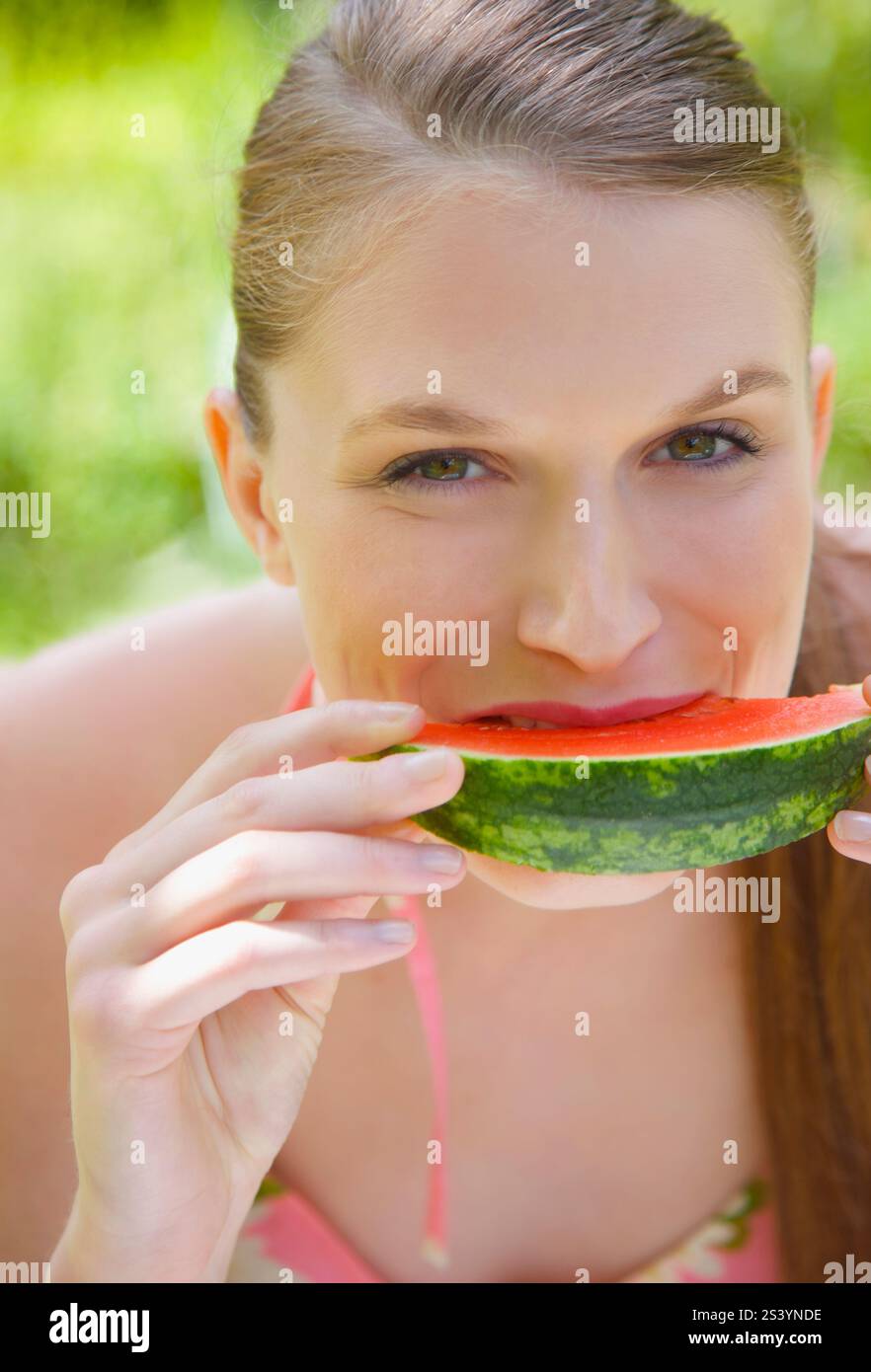 Young woman eating watermelon Stock Photo - Alamy
