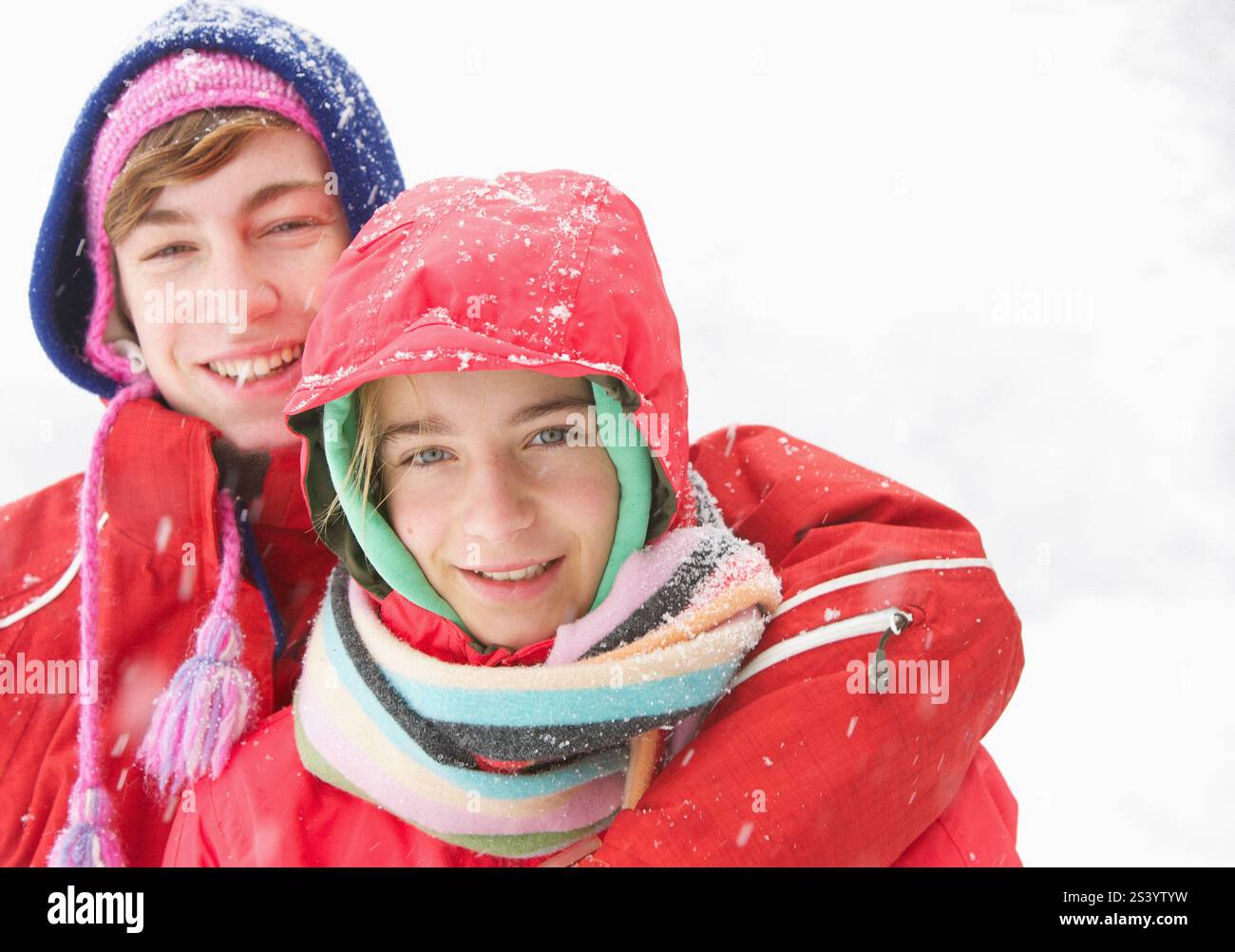 Boy and Girl Hugging under Snow Stock Photo - Alamy
