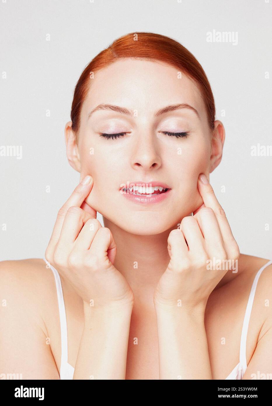 Young Woman Pulling Cheeks Stock Photo - Alamy