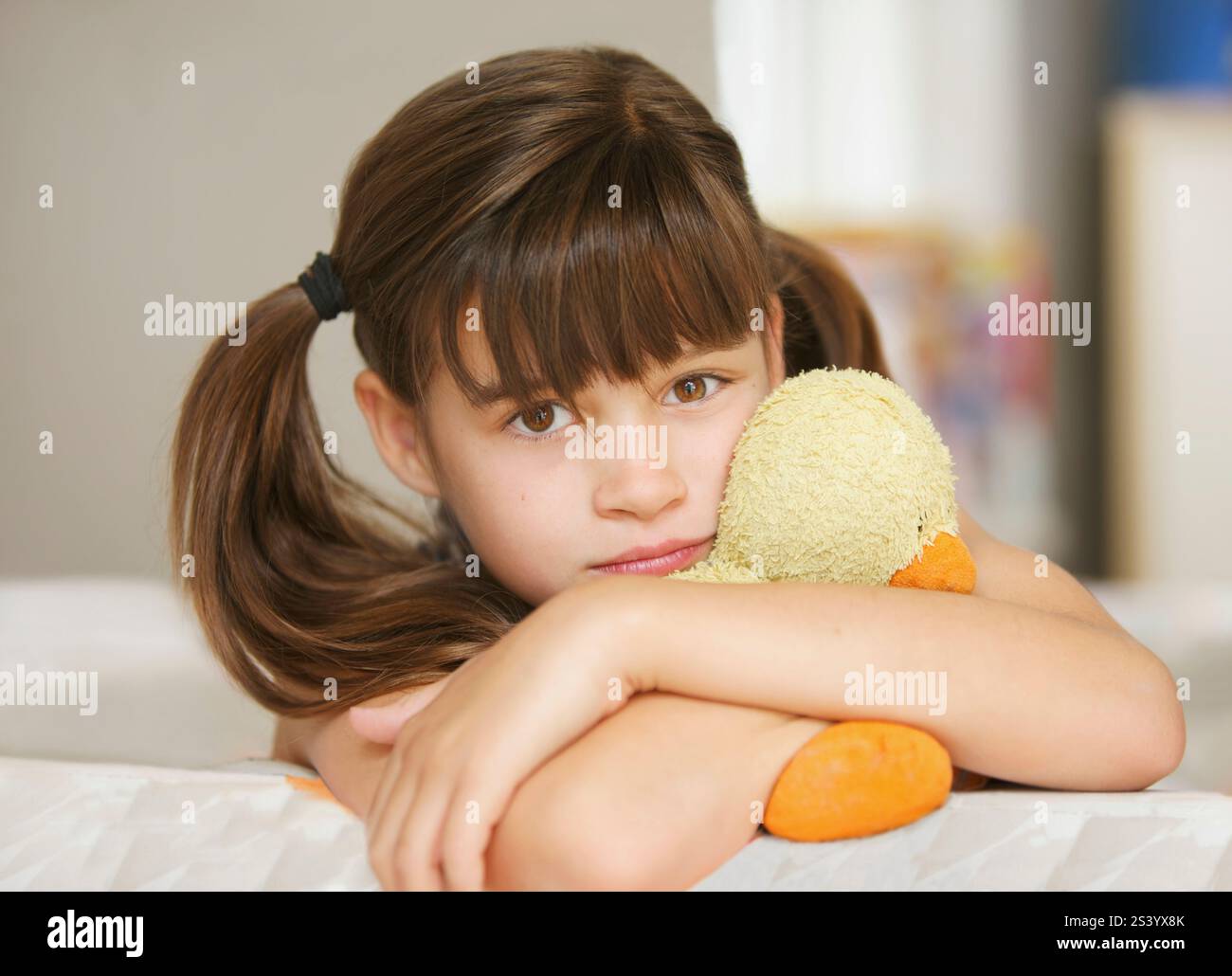 Girl Hugging a Stuffed Toy Duck Stock Photo - Alamy