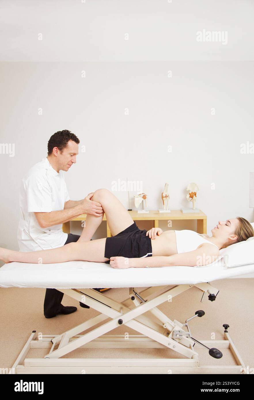 Osteopath Treating Female Patient Stock Photo - Alamy