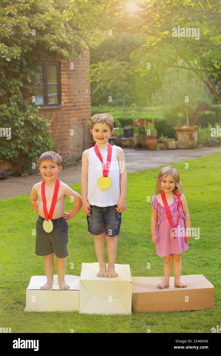 Children Standing on Cardboard Podium with Medals Stock Photo - Alamy