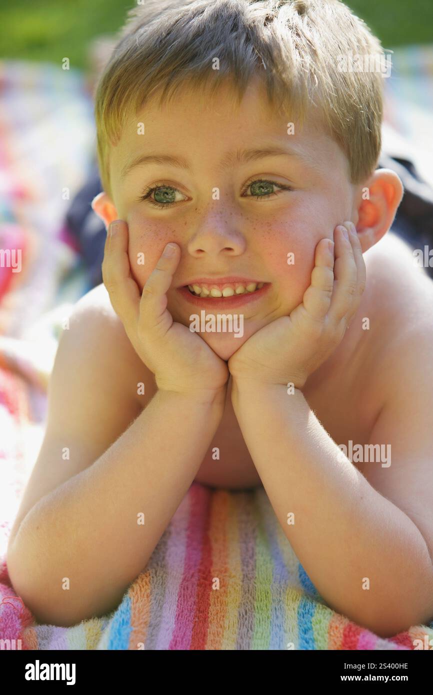 Young Boy with Hands on Chin Stock Photo - Alamy