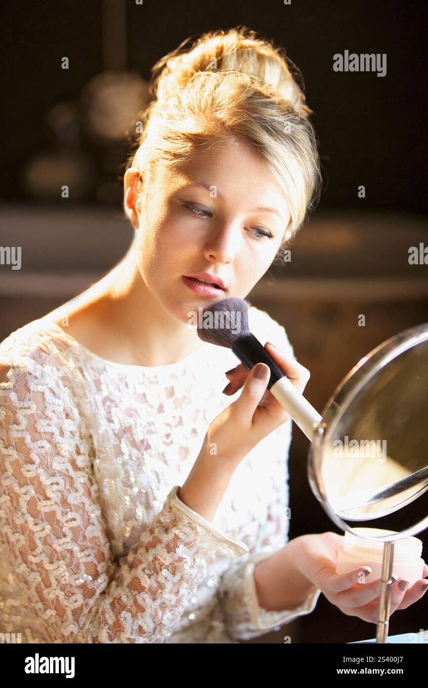 Young Woman Applying Blush Stock Photo - Alamy
