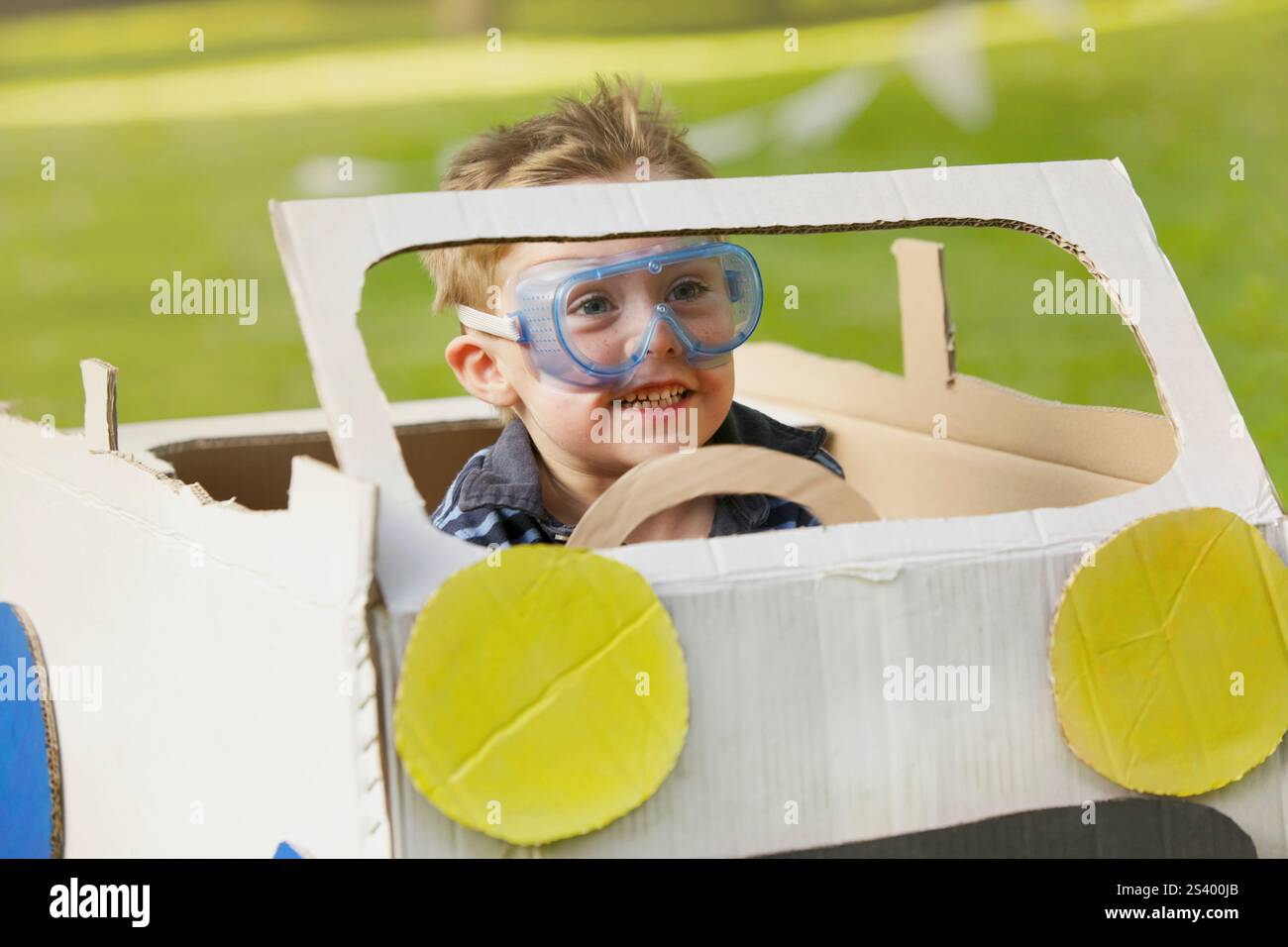 Boy Wearing Goggles Driving Cardboard Car Stock Photo - Alamy