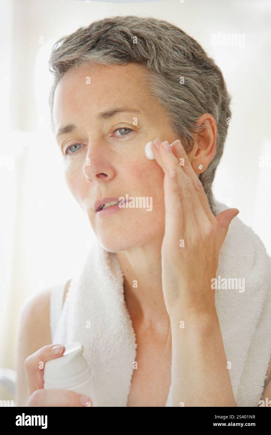 Woman applying moisturizer neck hi-res stock photography and images - Alamy