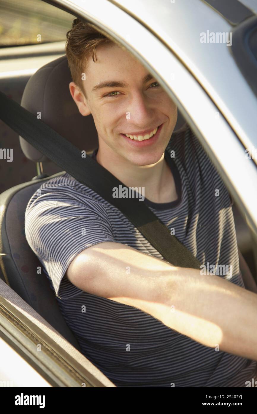 Smiling Teenage Boy Driving Car Stock Photo - Alamy