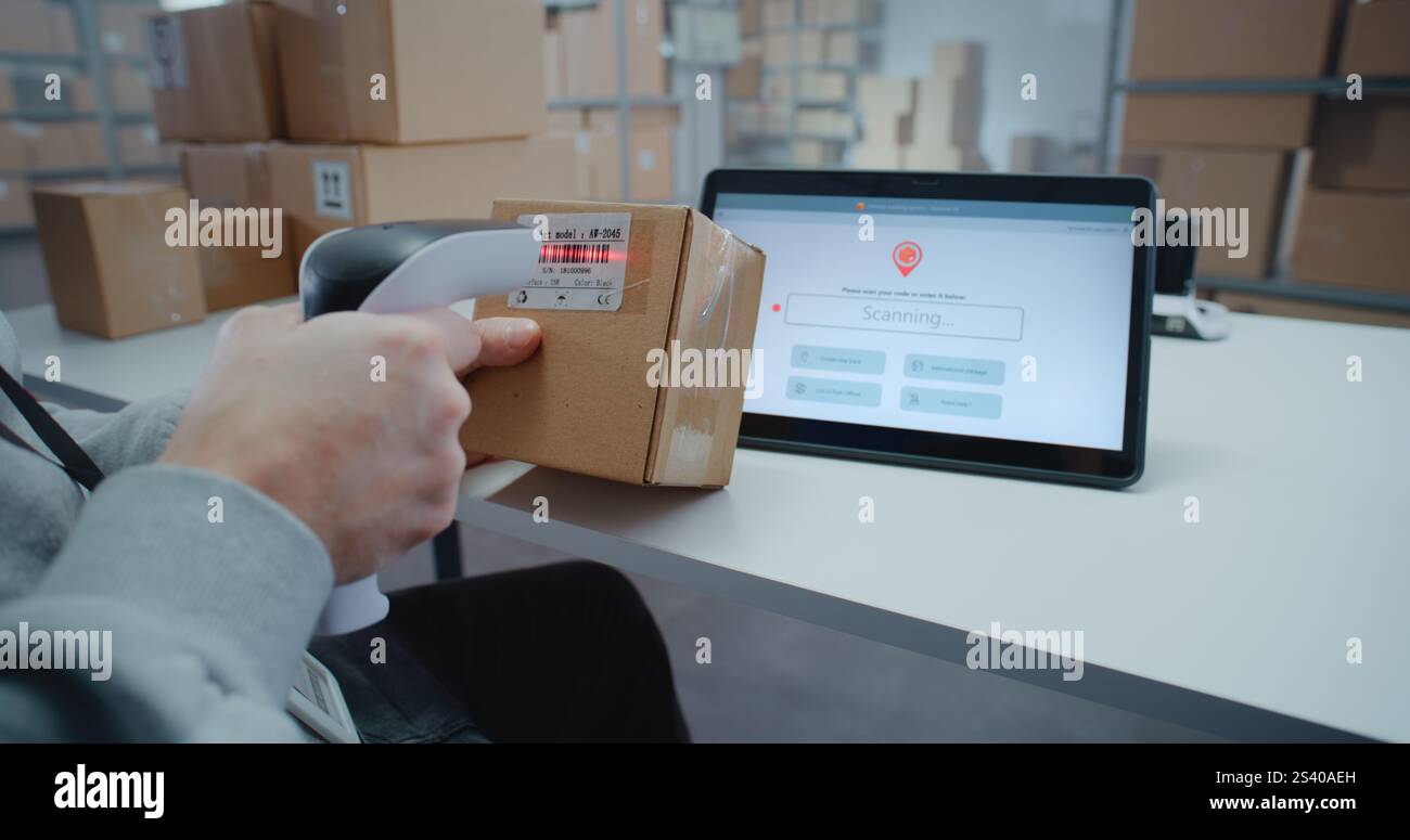 Postal Service Employee Scans Code on Cardboard Box with Barcode Scanner, Checks Parcel ...