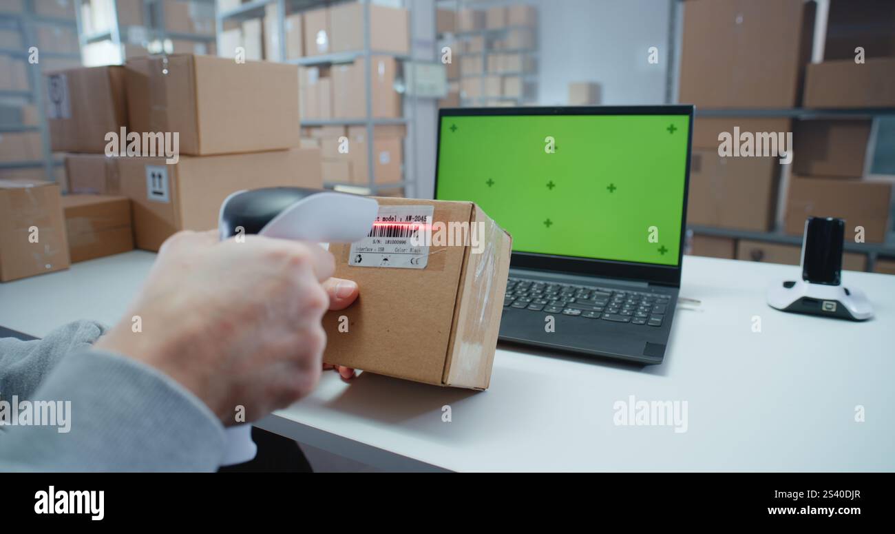 Postal Warehouse Associate Scans Code on Cardboard Box with Barcode Scanner, Checks Parcel ...