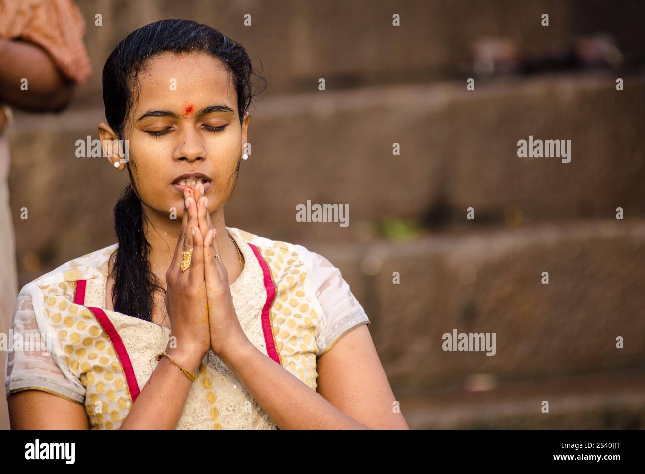 Devotees engage in spiritual cleansing in the Ganges River, surrounded ...