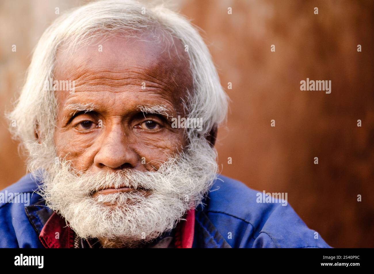 Elderly man in traditional attire at a vibrant cultural festival in ...