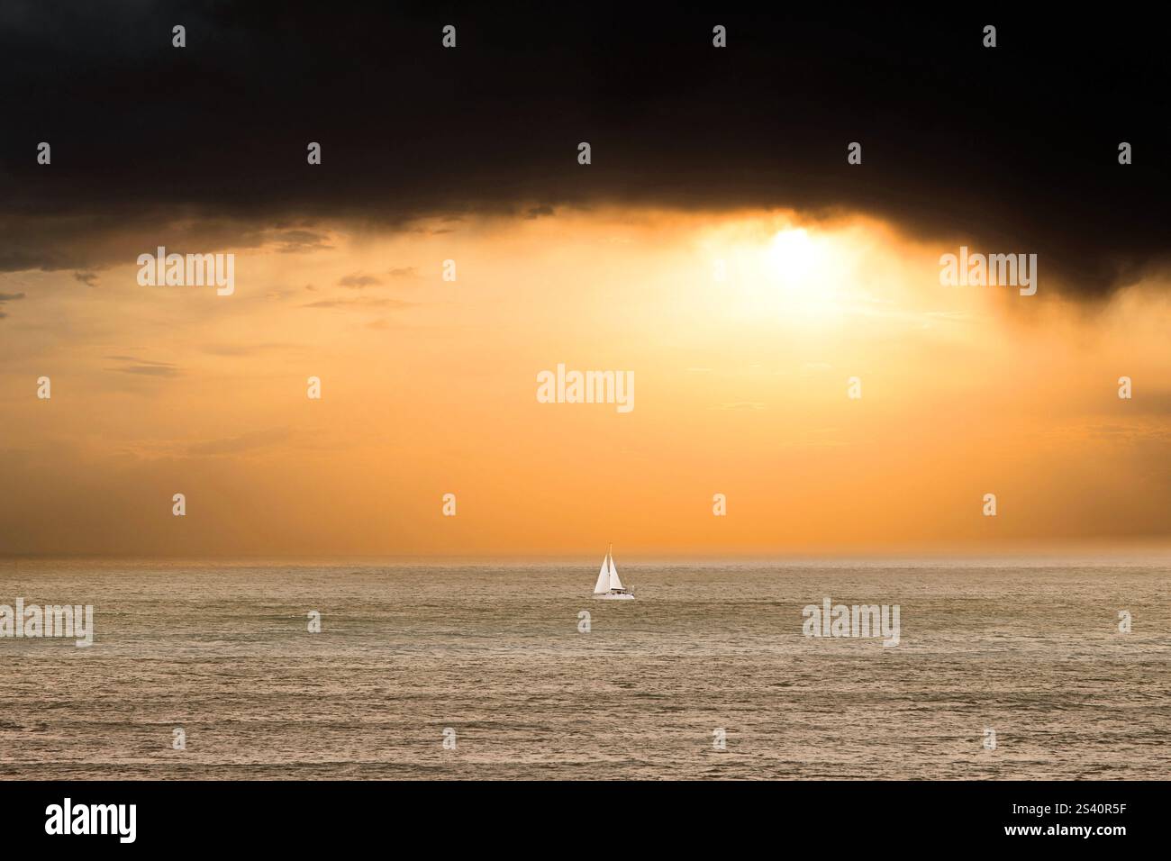 Racing the storm a small yacht scurrying along in the North sea before ...