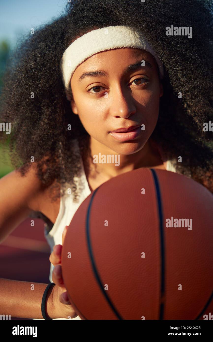 Closeup portrait view of young teenager woman with basketball ball ...