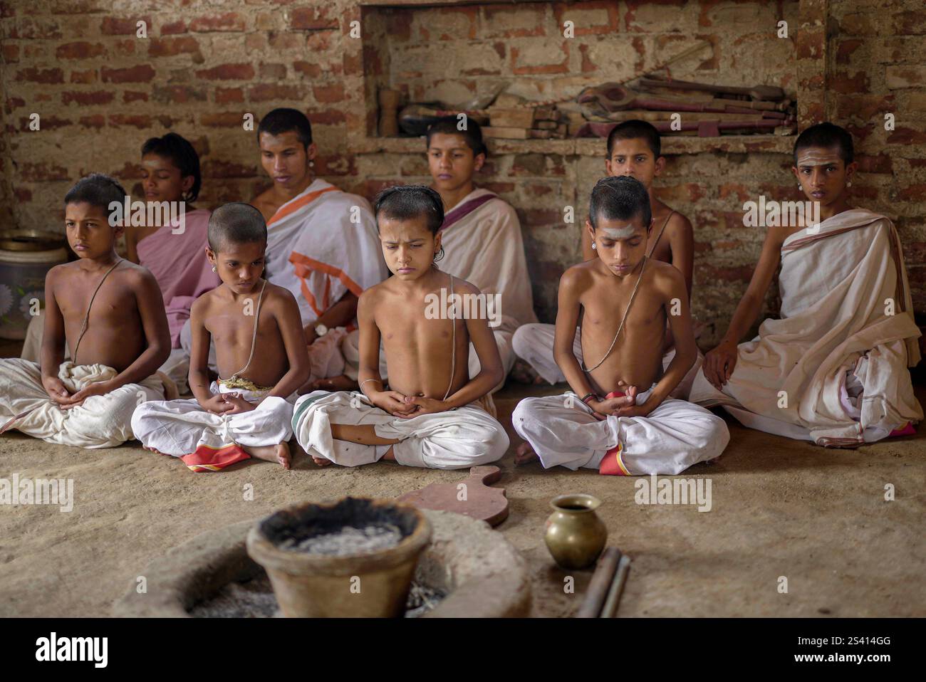 Young boys seated in meditation wearing traditional Indian attire ...