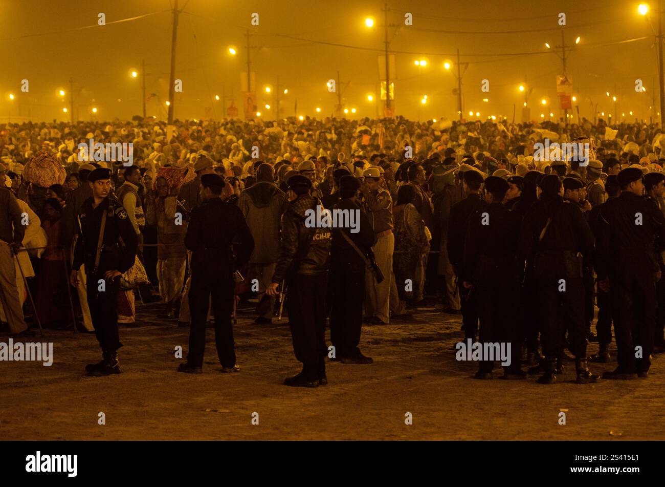 Crowd celebrating cultural festival at night with vibrant lights and ...