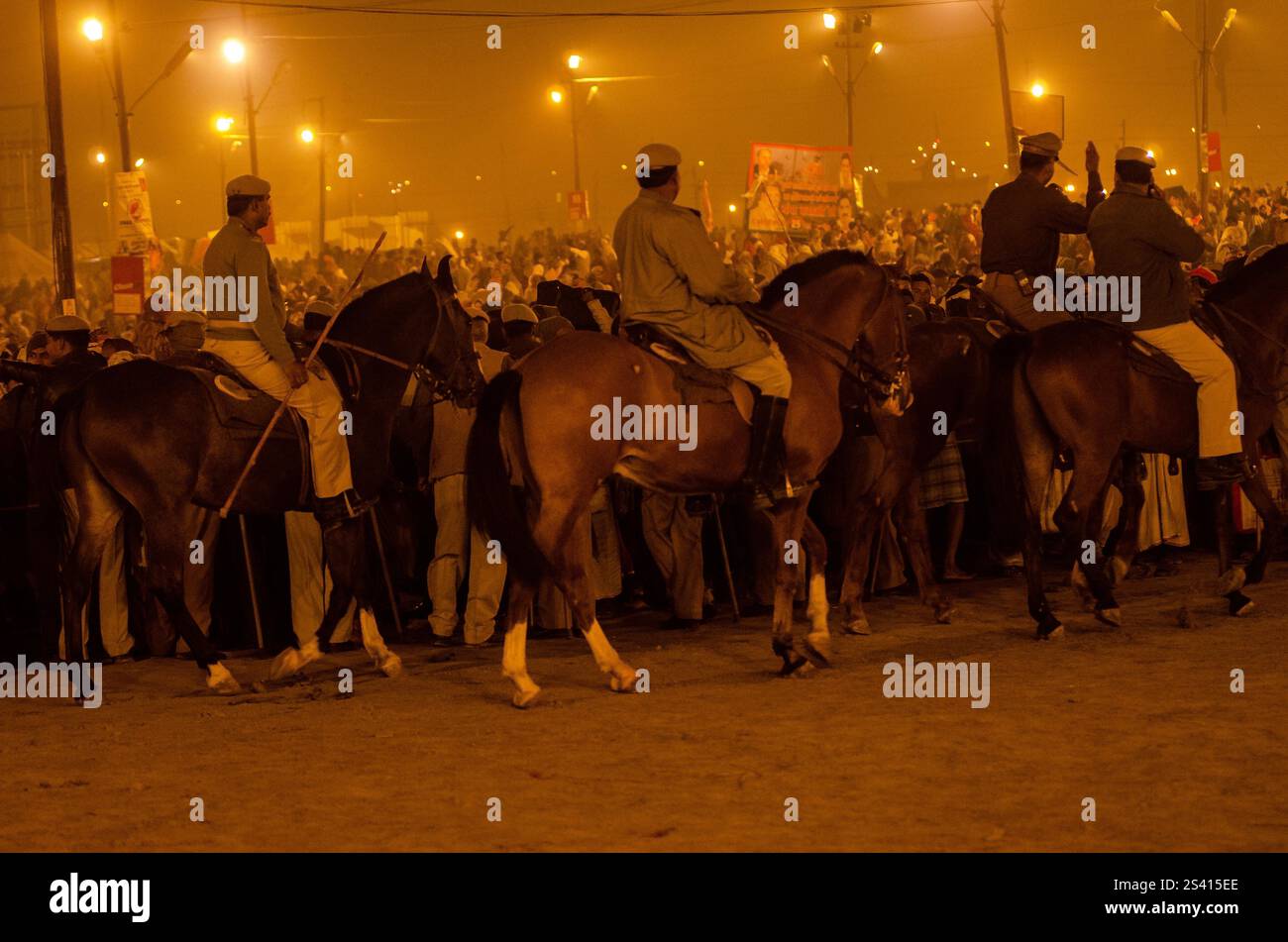 Crowd celebrating cultural festival at night with vibrant lights and ...