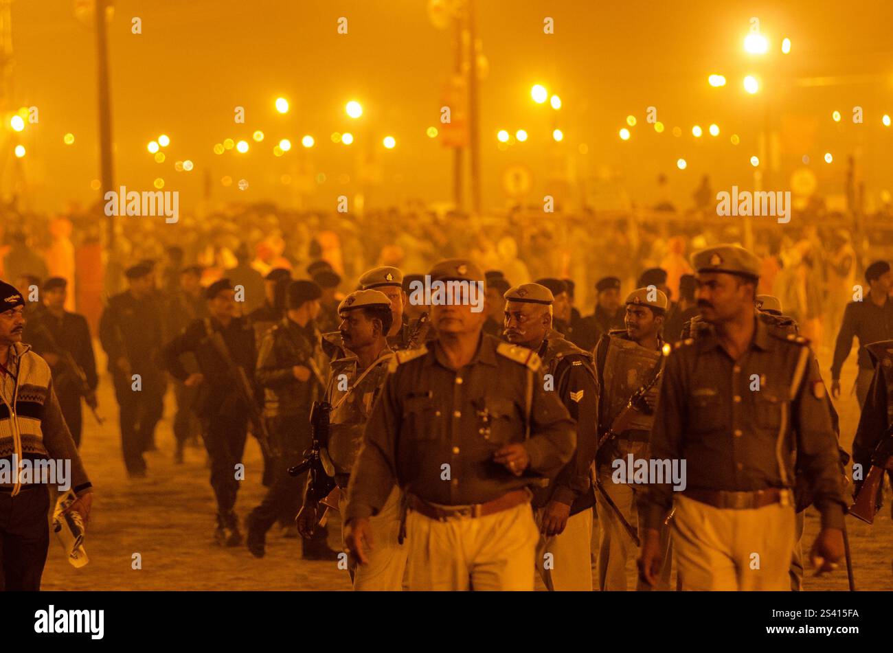 Security personnel patrol a crowded area at night during a significant ...