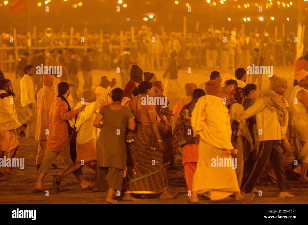 Crowd celebrating cultural festival at night with vibrant lights and ...