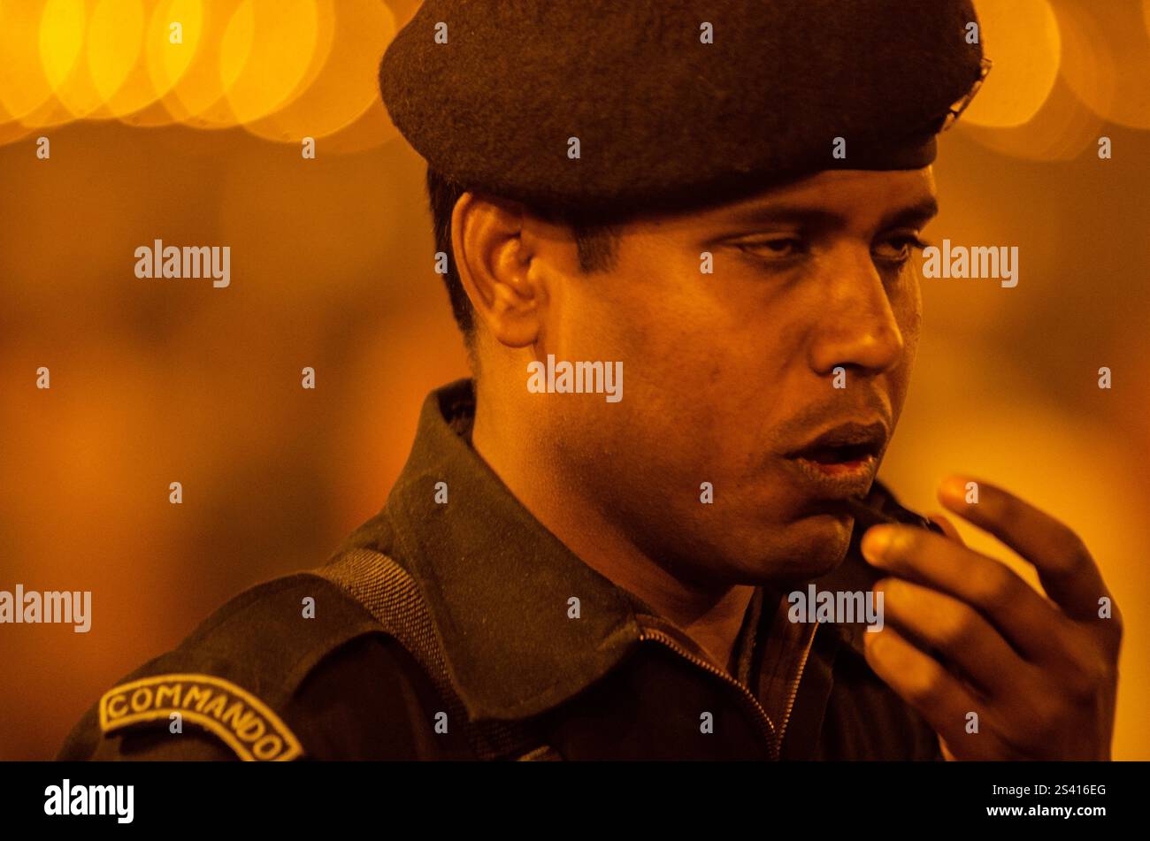 Security personnel patrol a crowded area at night during a significant ...