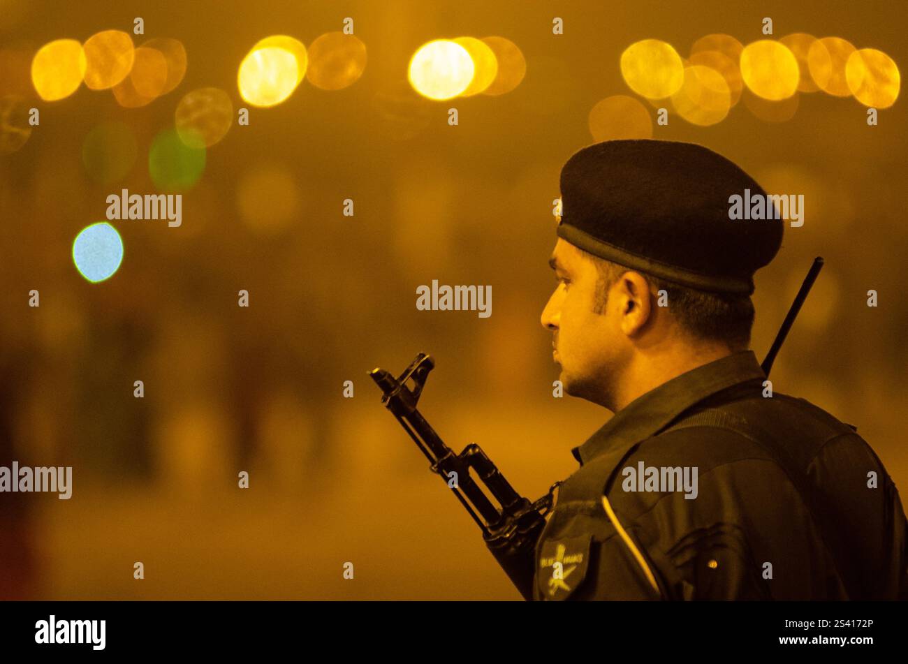 Security personnel patrol a crowded area at night during a significant ...