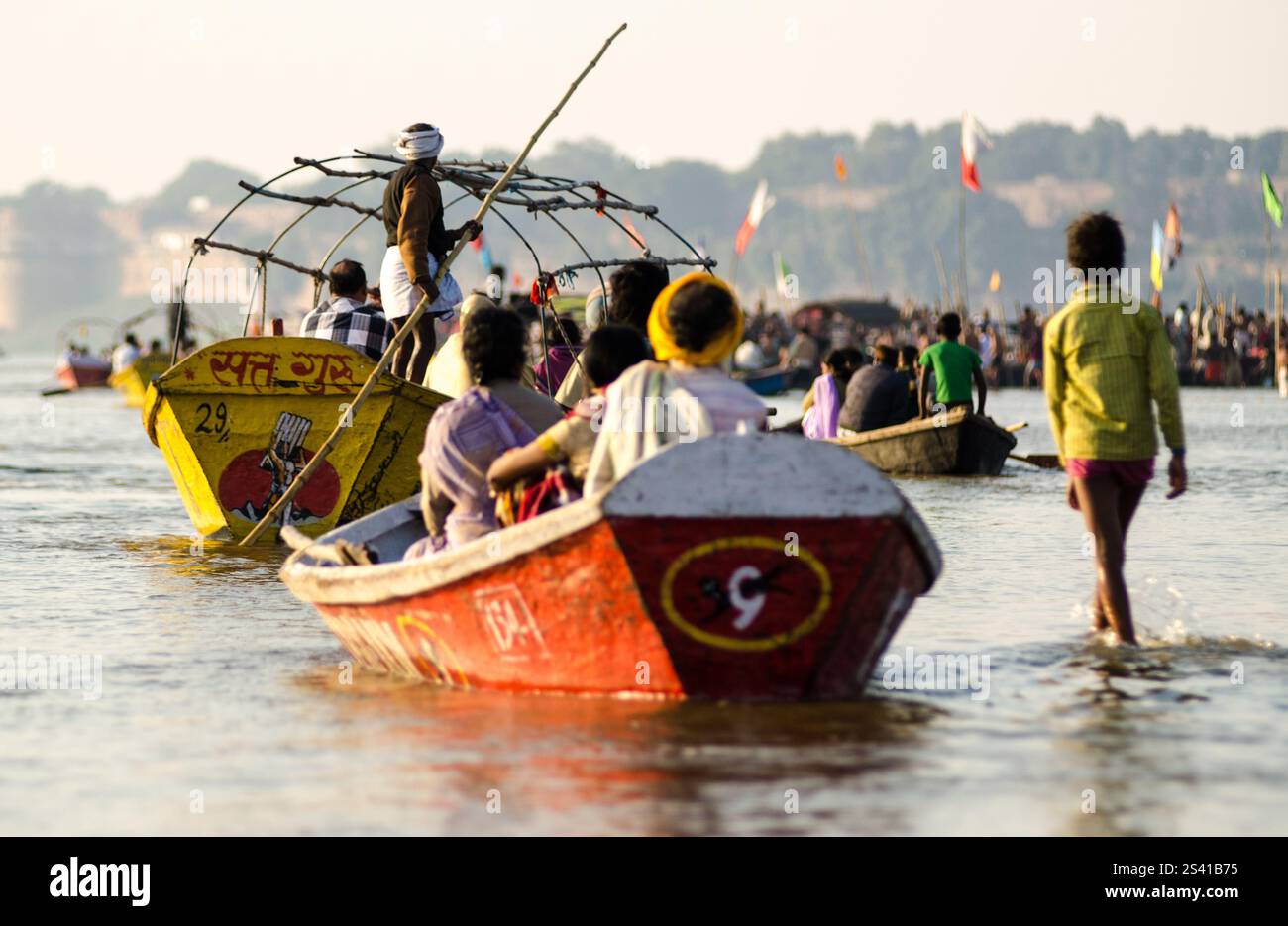 Boats navigate tranquil waters during a traditional river festival in ...