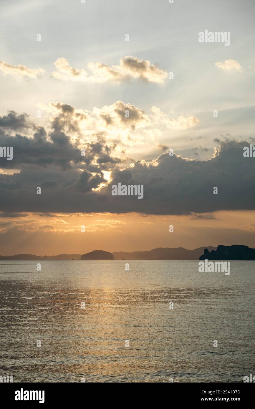 Tropical sunset over the ocean with distant island in view hi-res stock ...