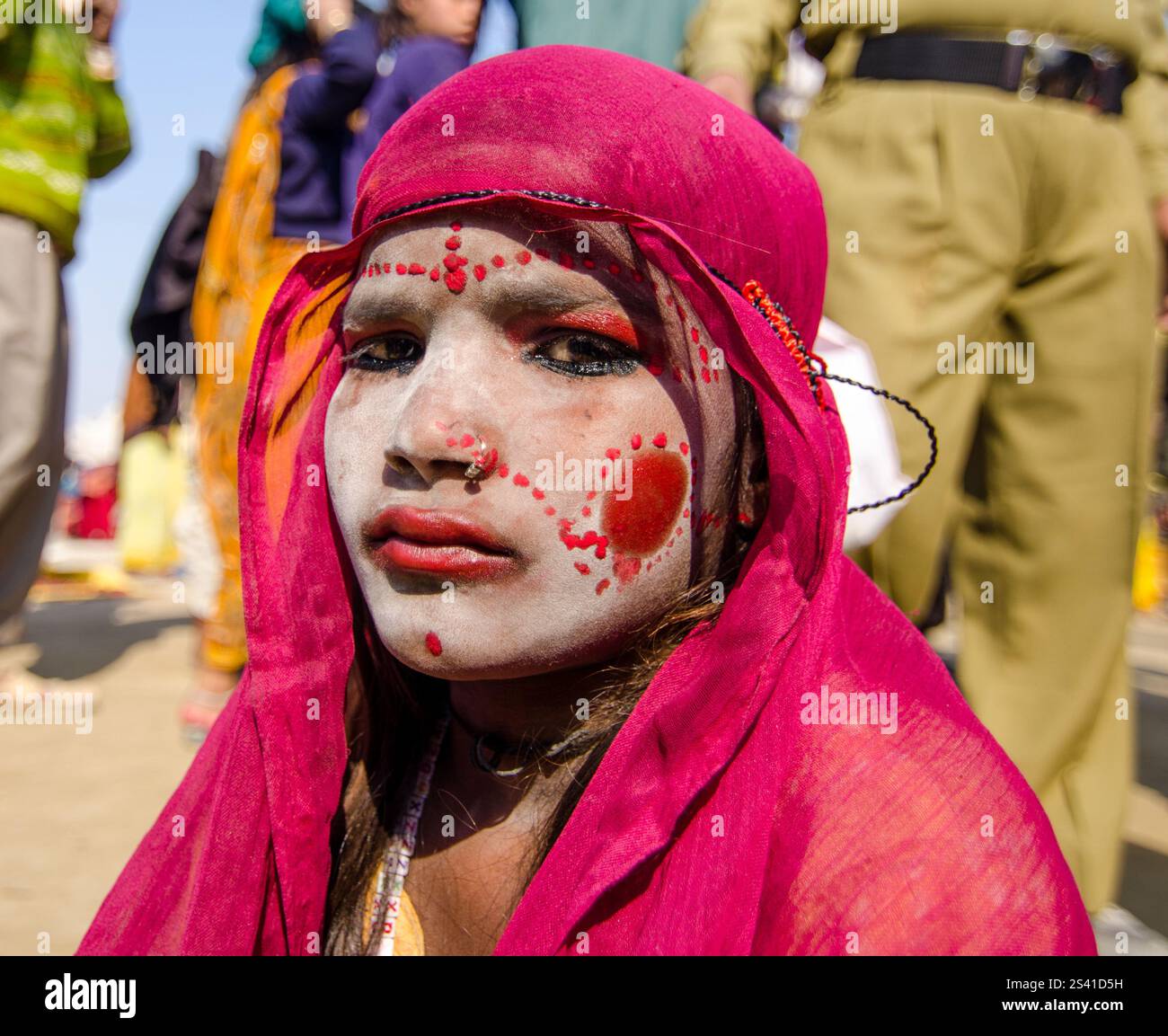 Girl with traditional makeup at a cultural festival among gathering ...
