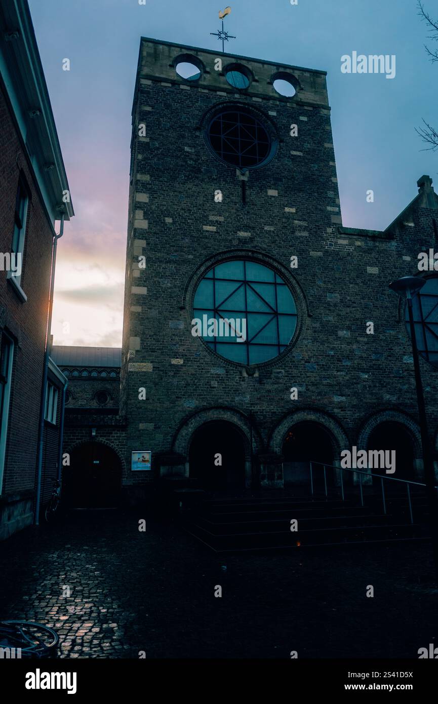 Historic brick church with large circular stained glass windows ...
