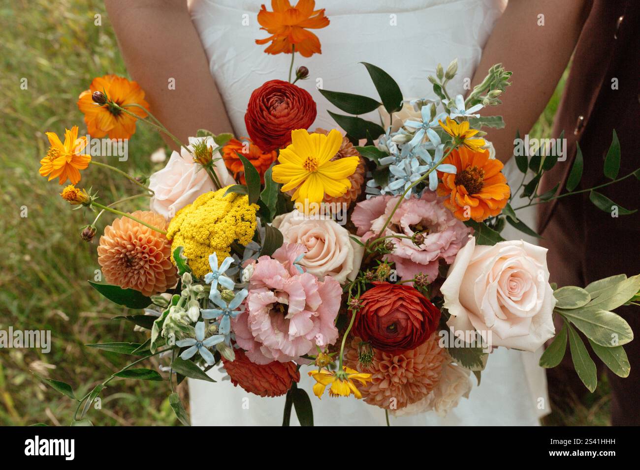 Bride holding nontraditional bold wedding bouquet Stock Photo - Alamy