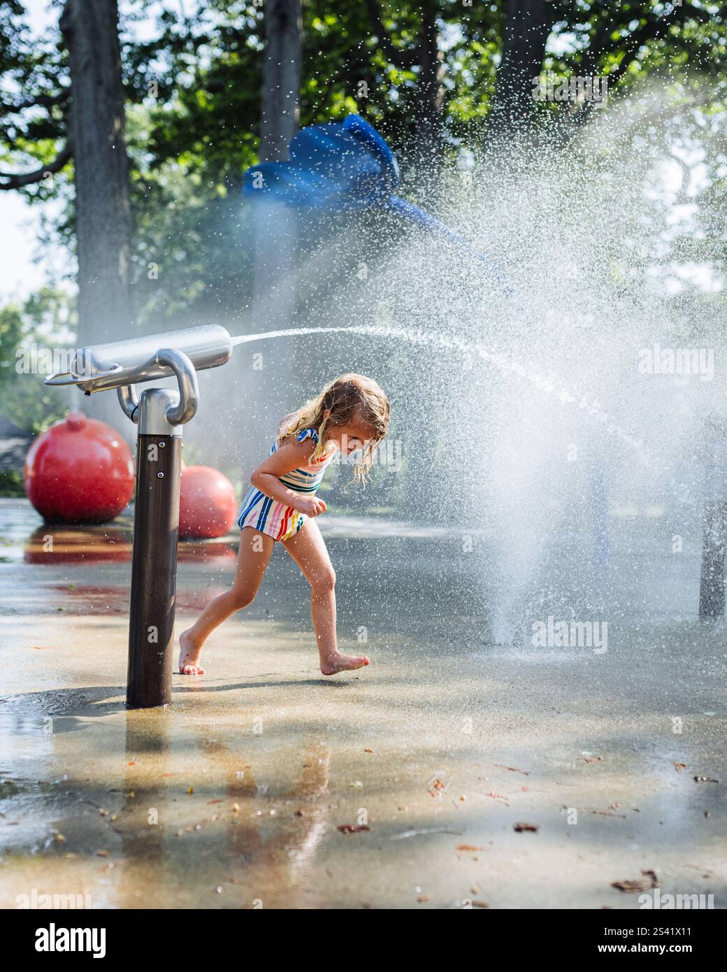 Sprinkler Summertime Play young girl Stock Photo - Alamy