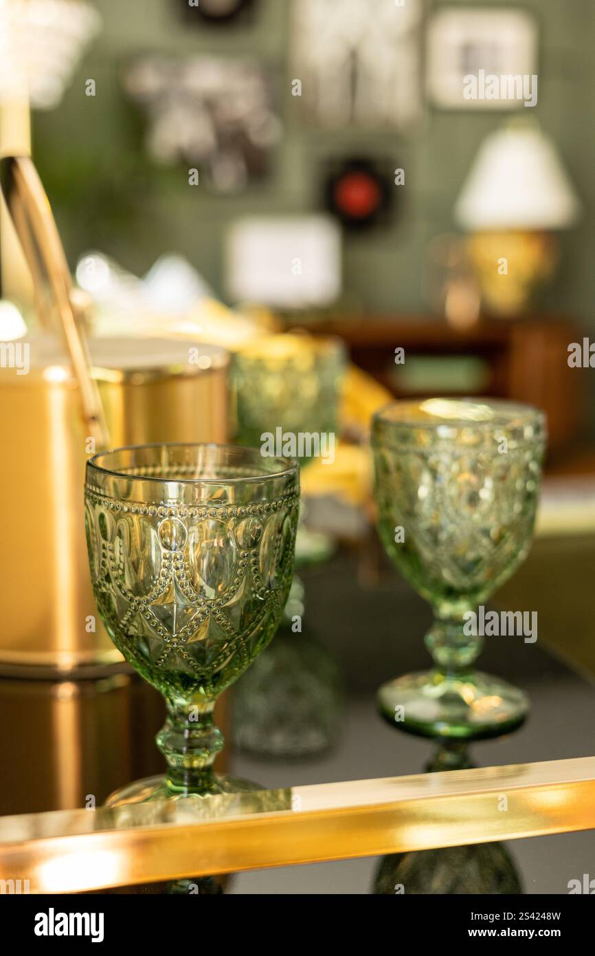 Vintage green glass goblets on an elegant reflective surface Stock ...