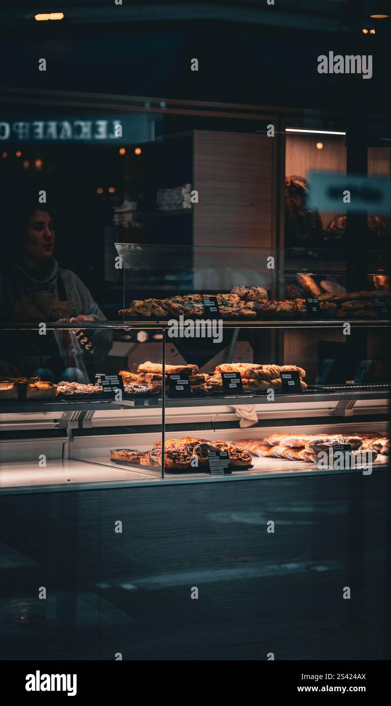 Bakery display showcasing assorted baked goods in a cozy urban setting ...