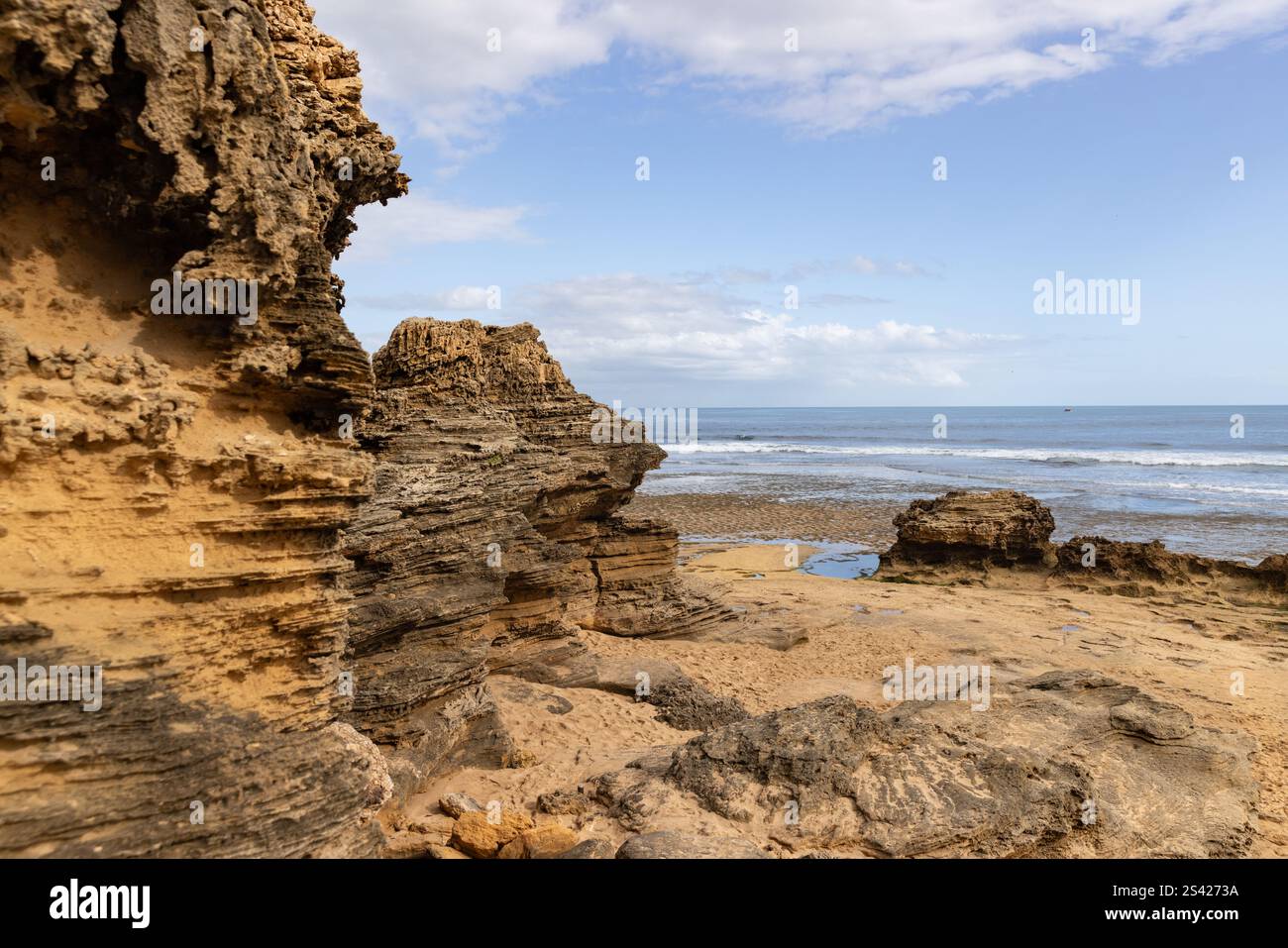Large textured Rock formations and cliffs framing an ocean view Stock ...