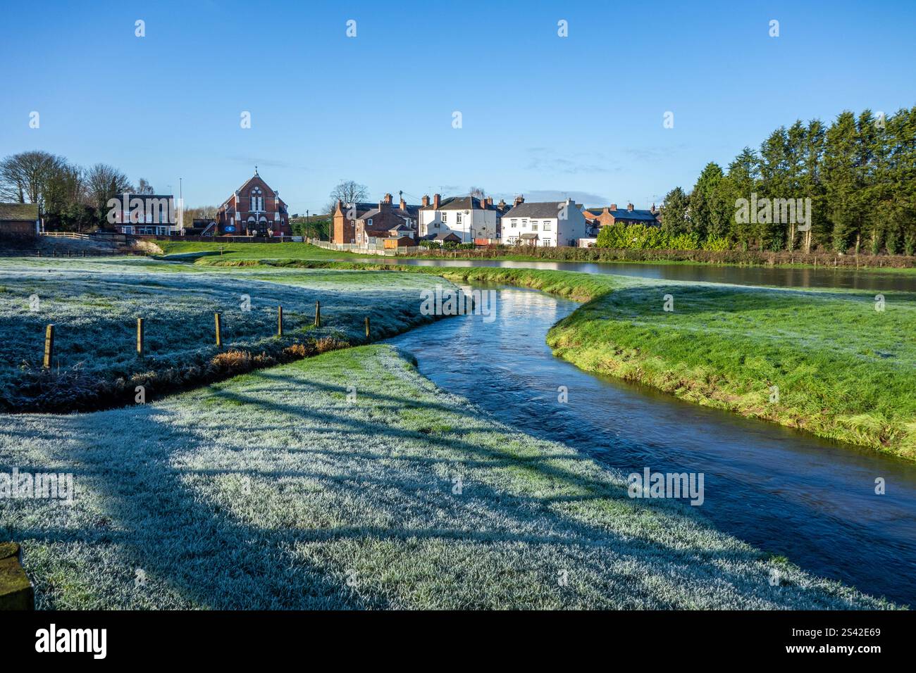 The river Wheelock in flood running through the Cheshire village of ...
