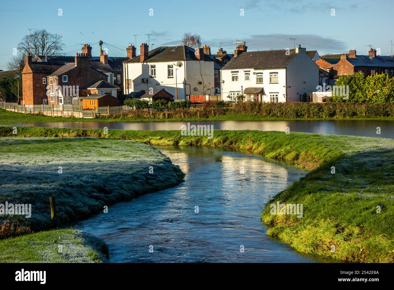 The river Wheelock in flood running through the Cheshire village of ...
