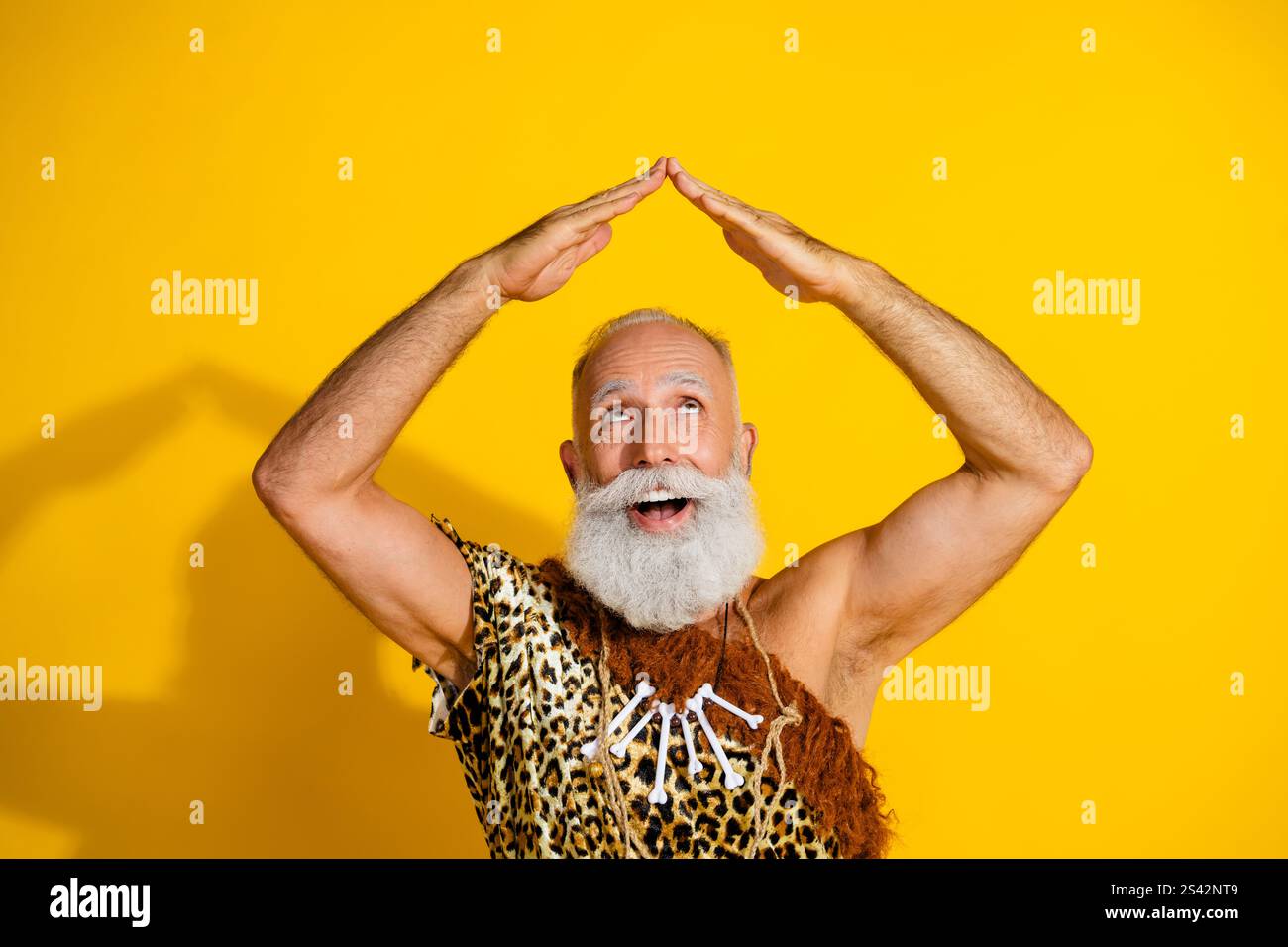 Photo of ancient aged caveman look hands roof above head wear leopard ...