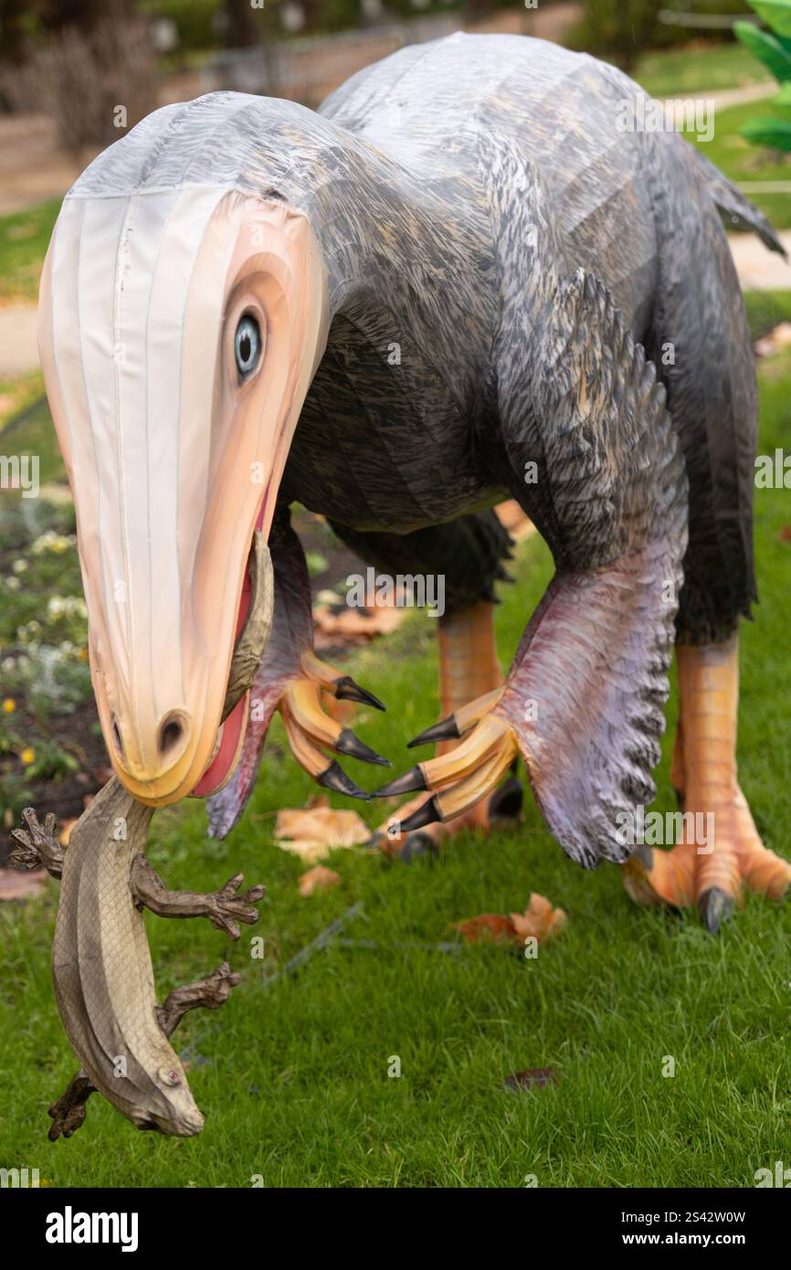 Large sculpture of a prehistoric bird hunting a reptile in a public ...