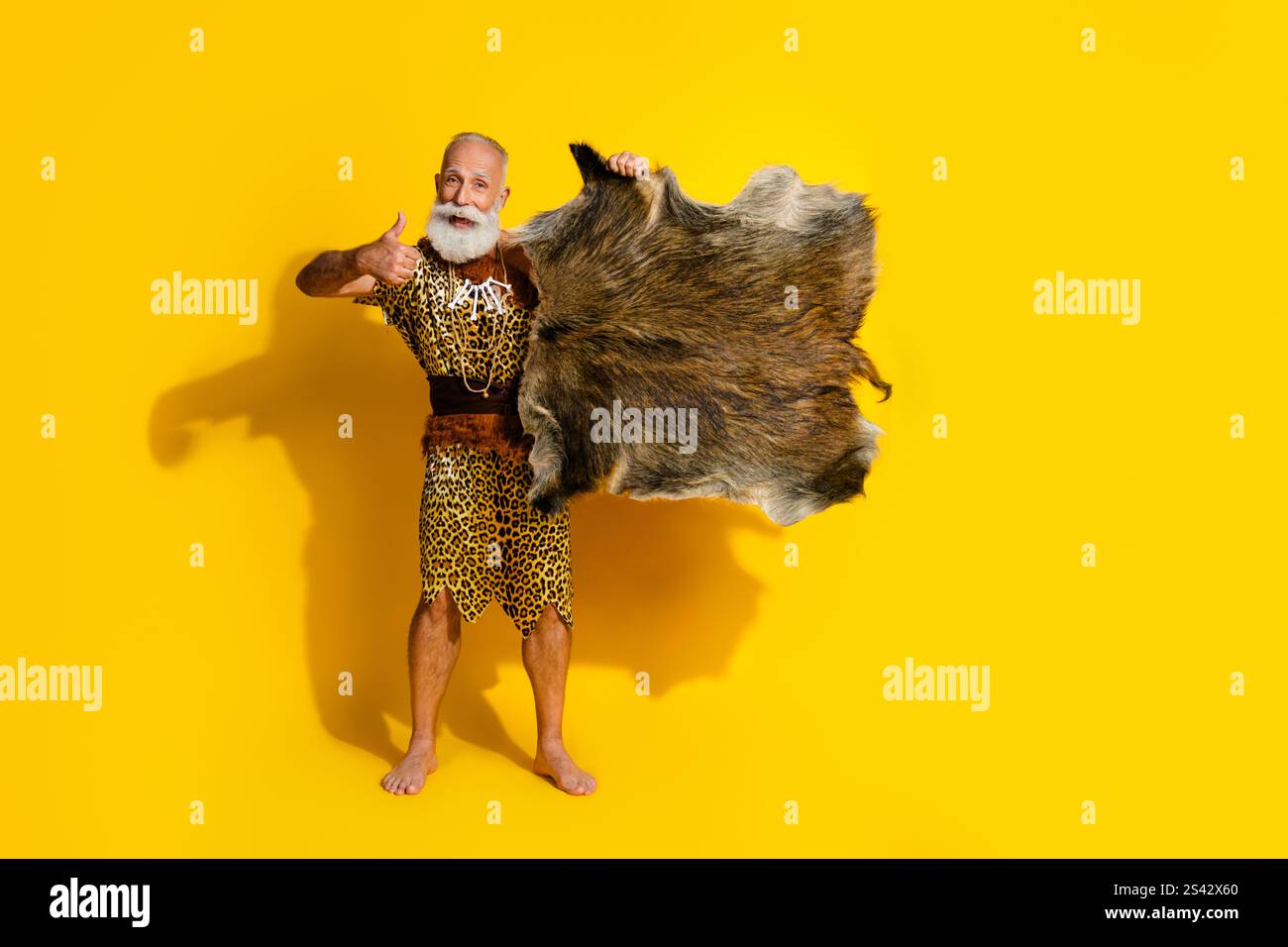 Full length photo of handsome neanderthal guy wear leoprad skin rising ...