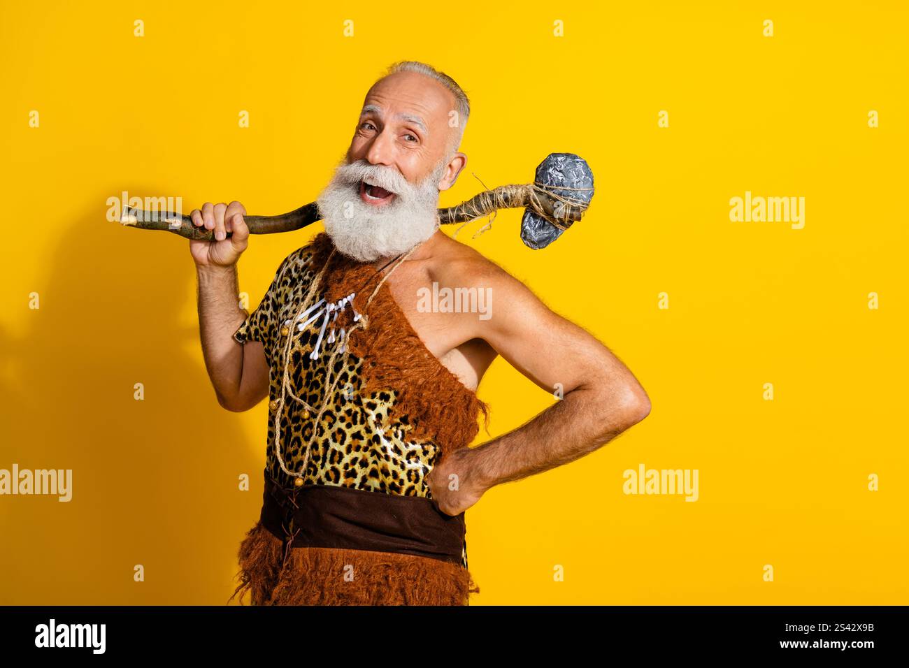 Photo of crazy caveman feel positive hold tool weapon on shoulder wear ...