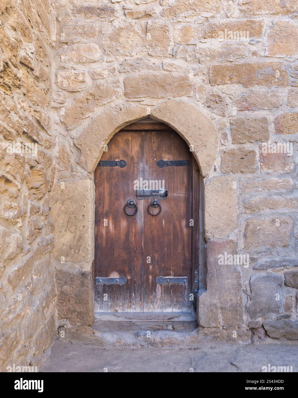 Imposing wooden door at the courtyard of Ateshgah Fire Temple, adorned ...