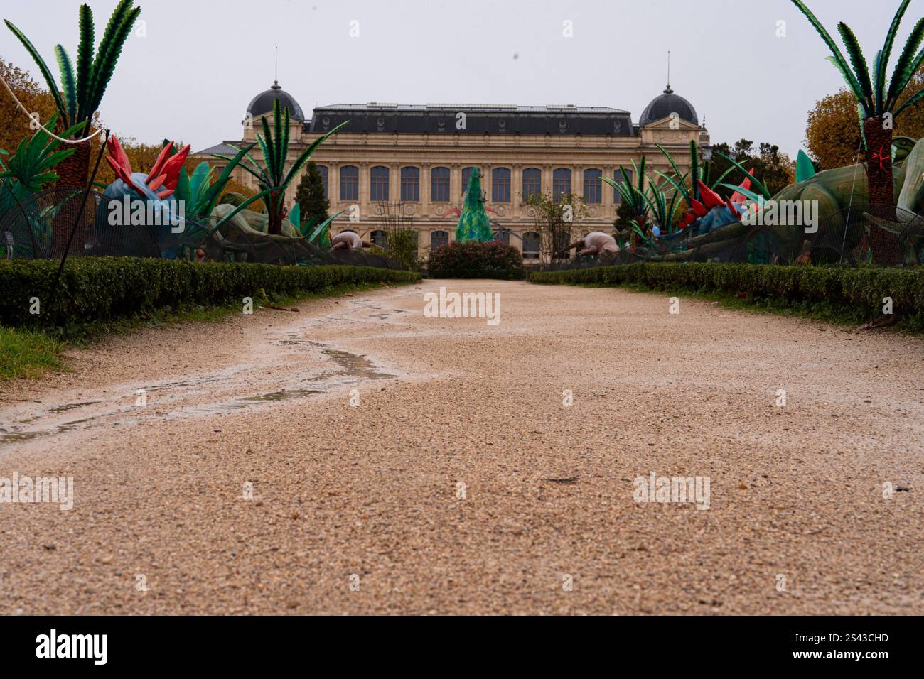 Historic garden path leading to a grand museum in autumn with ...