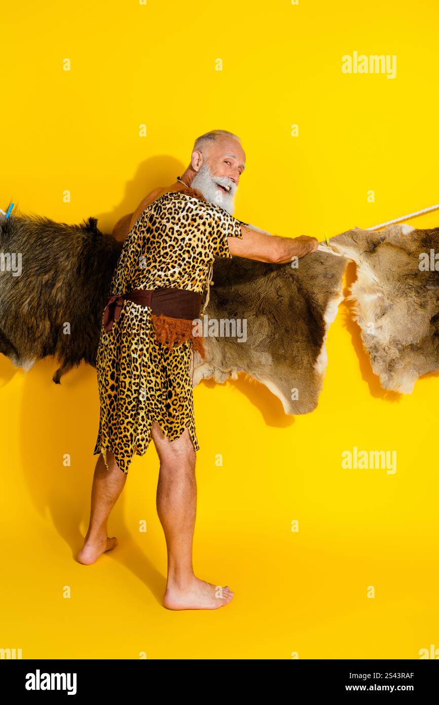 Vertical full length photo of strong paleolitic human wear leopard skin ...