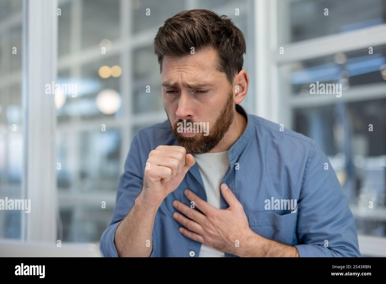 Sick coughing man close up. Office worker with cold at workplace in the ...