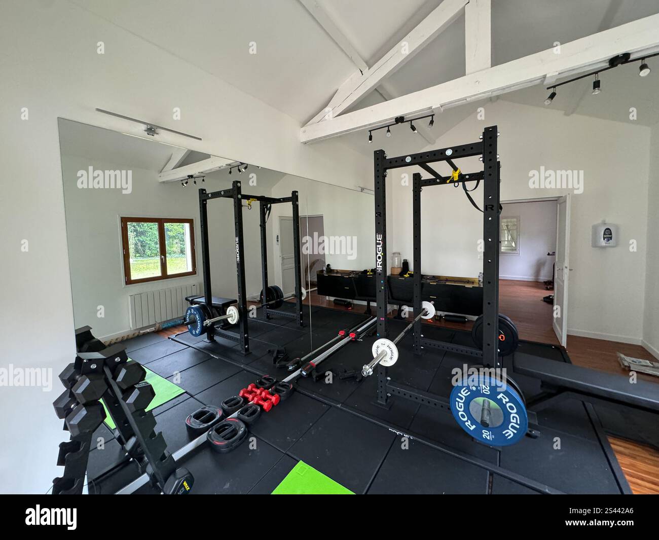 Modern gym interior featuring weightlifting equipment and open space in ...