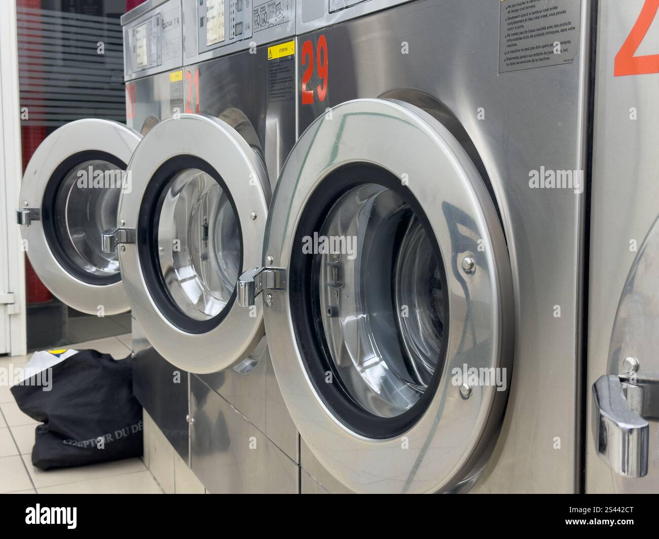 Modern laundry machines in a clean self-service laundromat during ...