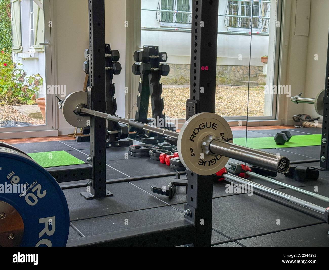 A well-equipped home gym featuring barbells and weights, perfect for ...