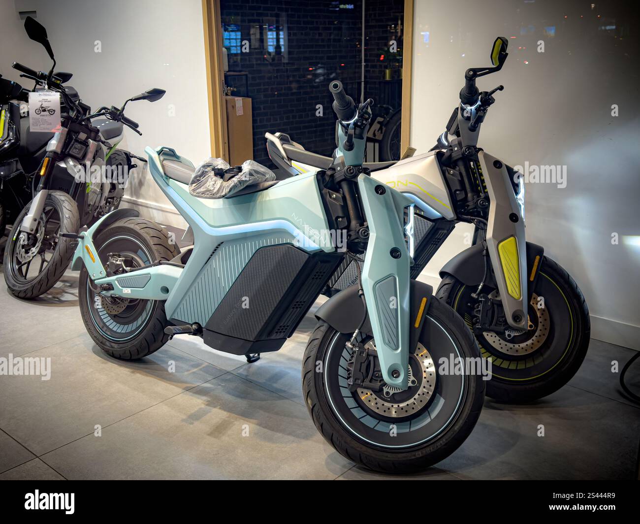 Electric motorcycles displayed in a modern showroom showcasing ...