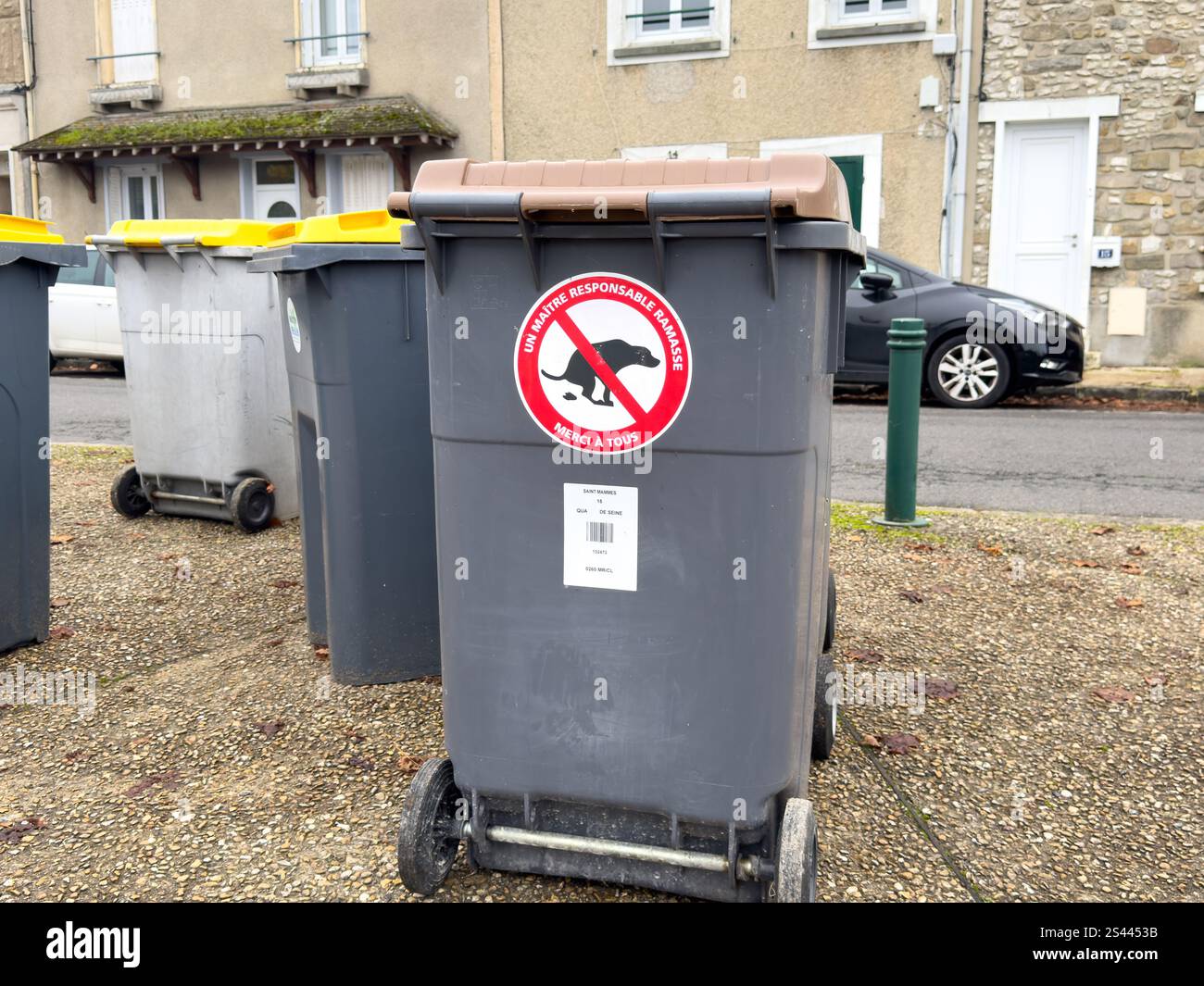 Garbage bins with warning signs against feeding stray animals in a ...