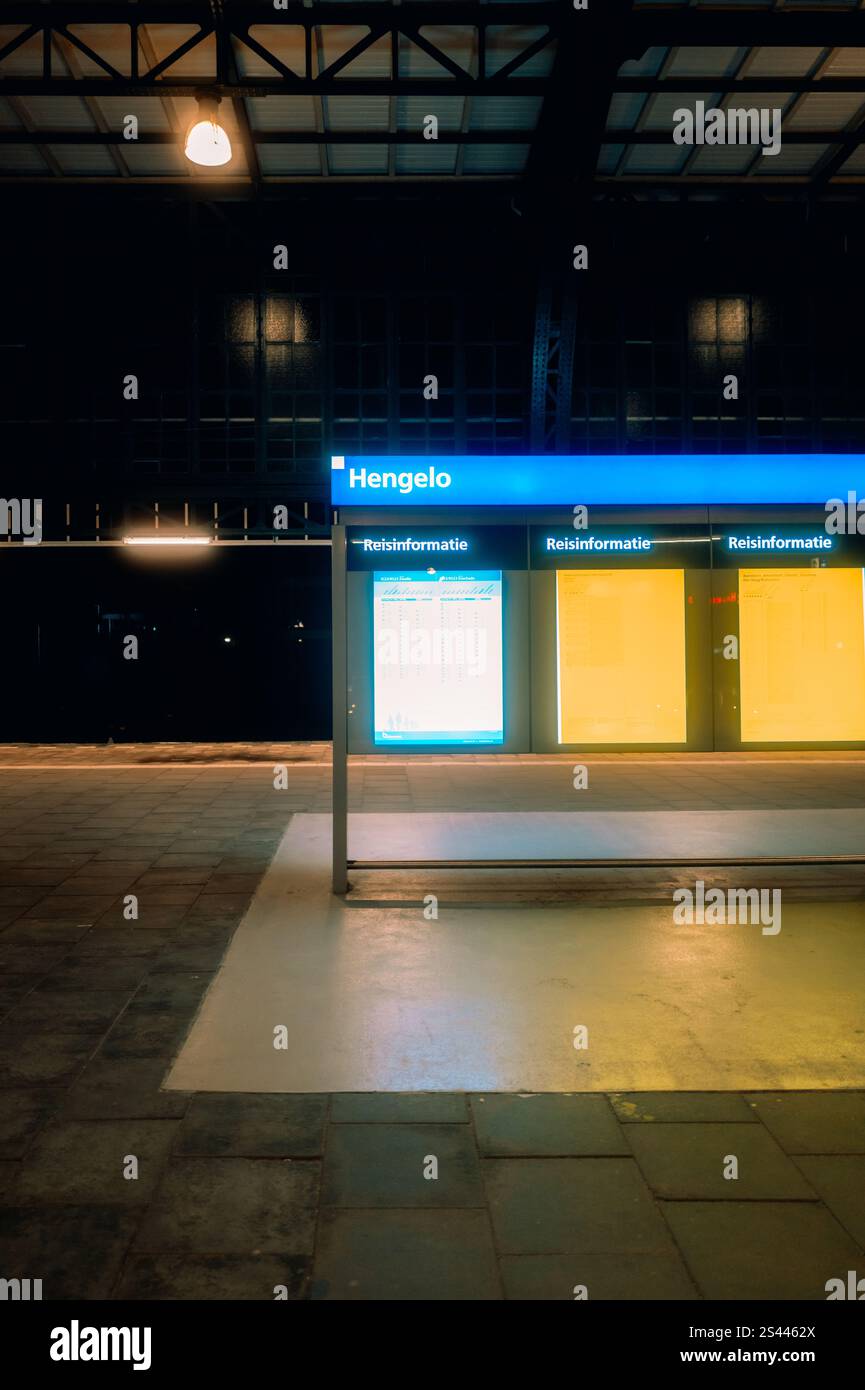 Night view of Hengelo station sign and information boards with ...