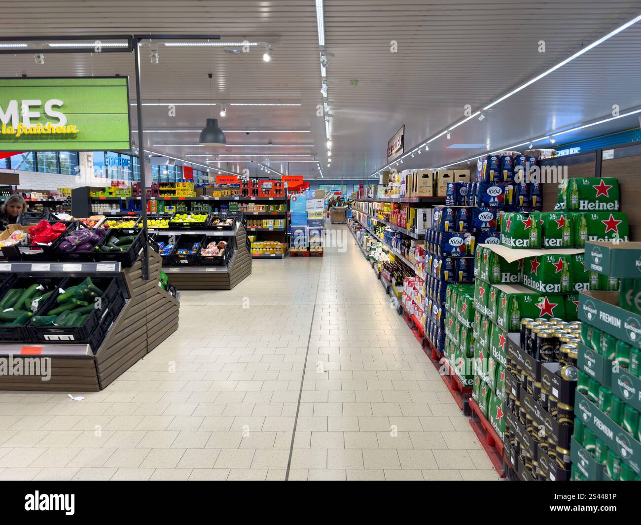 Grocery store interior displaying fresh produce and beverages during a ...